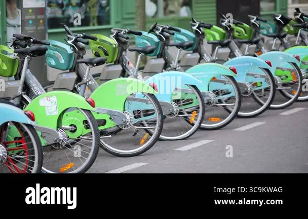 PARIS, FRANCE - MAY 31, 2025: People using bicycle sharing system Velib ...