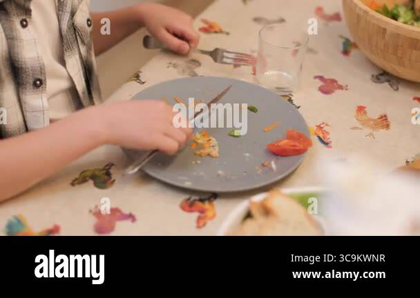 Detail shot of a child hands pushing back chair and picking up an empty ...
