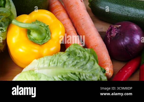 Close up of various healthy vegetables captured in slow motion on ...