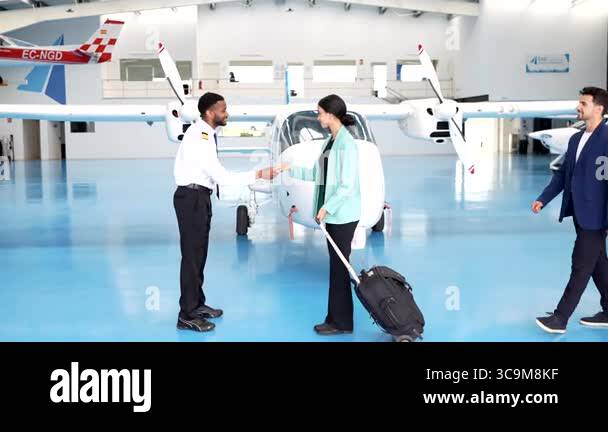 Passengers shaking hands with a pilot before boarding a private ...