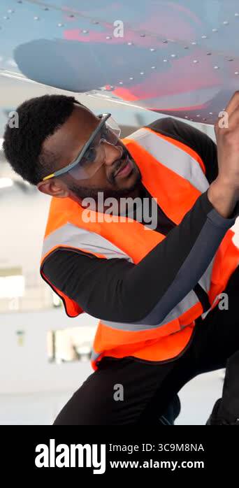 Maintenance engineer installing pitot tube on airplane wing, ensuring ...