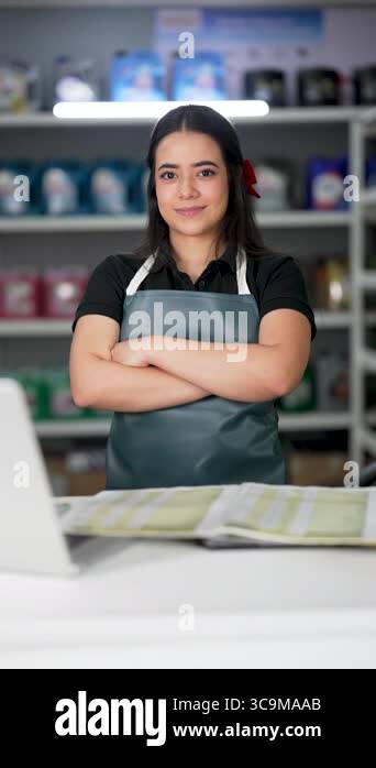 latin american young woman at counter using laptop and looking at ...