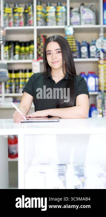 young latin american woman with tablet pc posing at the counter of a ...