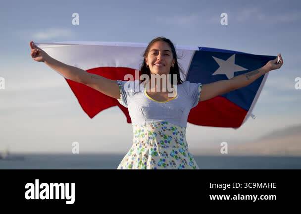portrait of beautiful latin woman holding a flag of Chile wearing ...