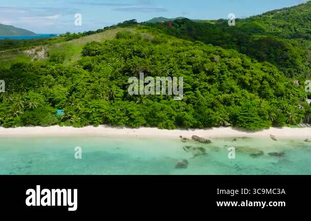 Drone view of Tiamban Beach and Nonok Beach Resort with white sand and ...