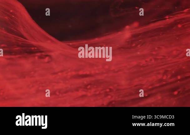 Blur spilling fluid. Water paint dripping. Defocused red color shine ...