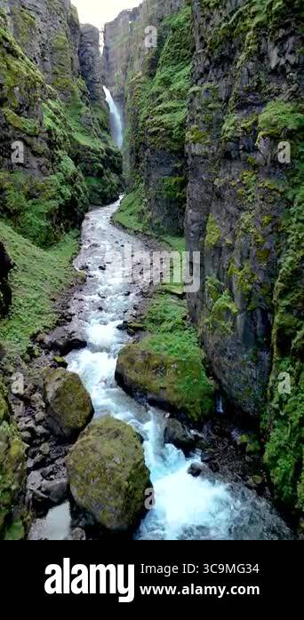 Glymur waterfall canyon Iceland, where a gentle river flows amidst ...