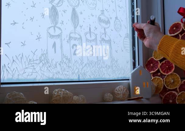 Painted window with white marker. Christmas advent candles decoration ...