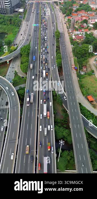 High-angle view of busy highway traffic, cars, trucks, and motorcycles ...