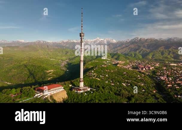 Aerial drone reveal shot of symbol Almaty city high TV tower and park ...