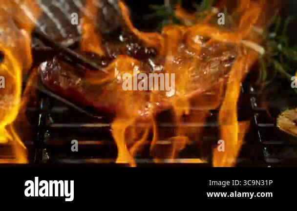 Slow Motion of Turning Beef Steak on a Grill with Roaring Flames ...