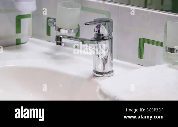 This elegant bathroom faucet showcases a shiny chrome finish and a ...