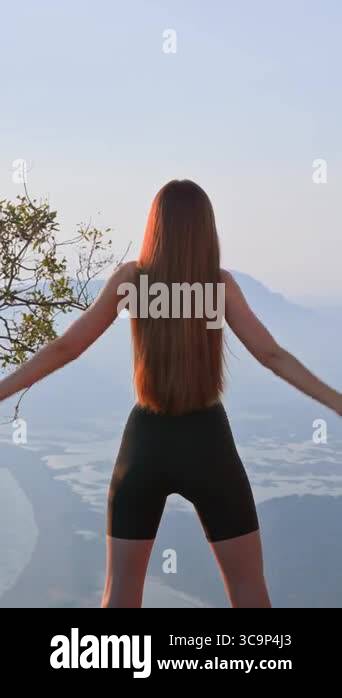 VERTICAL VIDEO: Woman in sportswear doing slow shoulder mobility ...