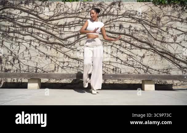 A confident and skilled dancer strikes a dynamic pose in their stylish ...