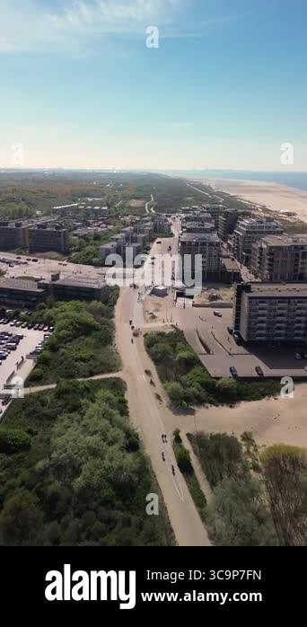 Aerial view of a modern beachside development with apartment buildings ...
