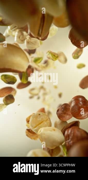 Super Slow Motion of Flying Nuts Mix in Rotating Movement. Filmed on ...