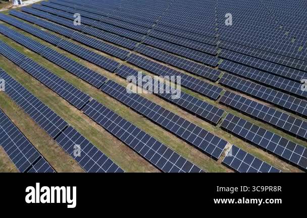 Aerial view of a large solar power plant with rows of photovoltaic ...