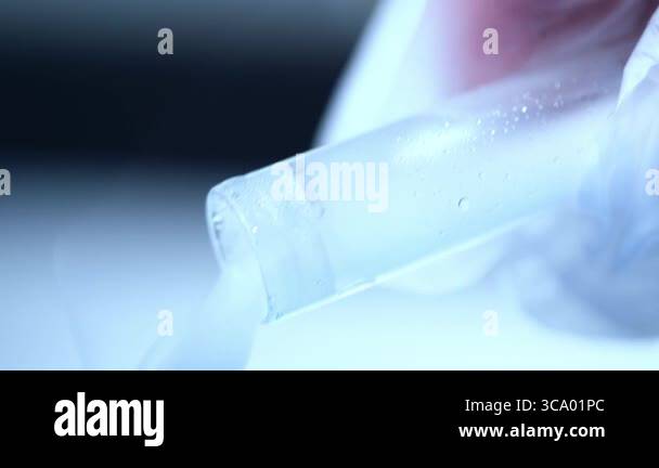 Testing sample of liquid in test tube close up zoom shot slow motion ...
