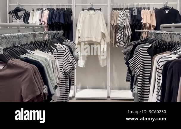 Boutique clothing display showcases patterned womens fashion on wooden ...