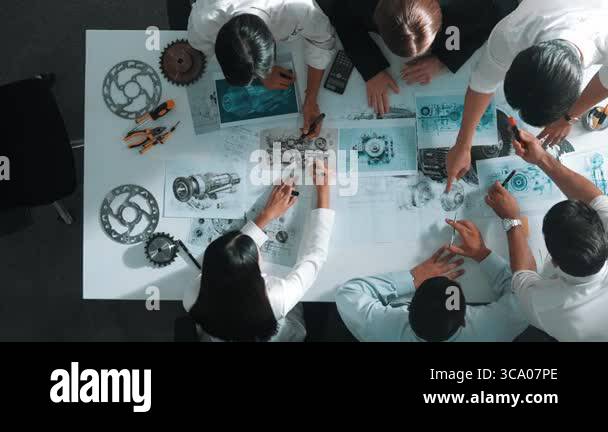 Top down view of skilled engineer showing and talking about turbine ...