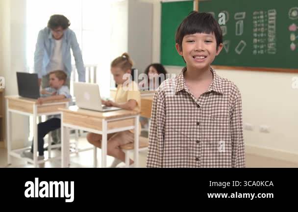 Skilled asian boy looking and waving hands while friend studying about ...