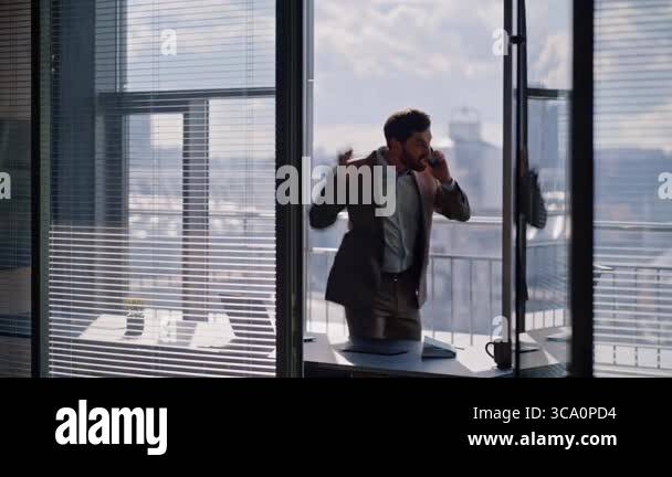 Furious manager calling phone gesturing emotionally standing at office ...