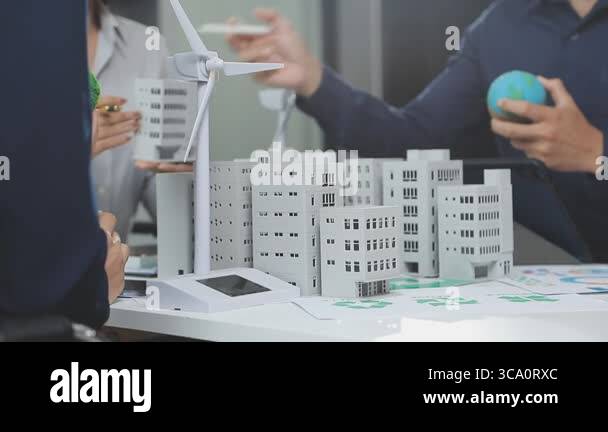 young man and woman working in the office with model building model and ...