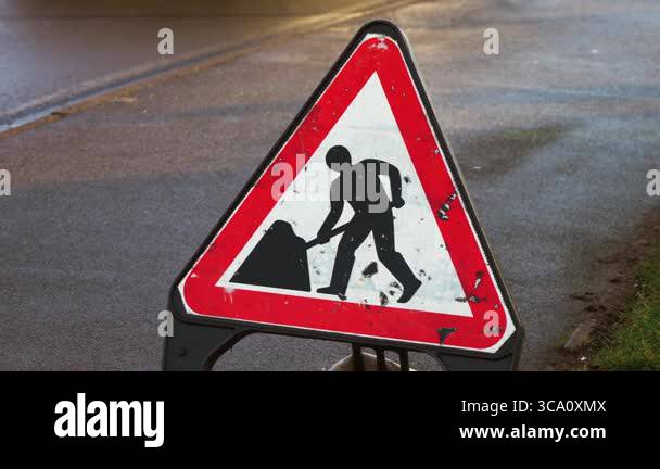 Road work warning sign in United Kingdom. Traffic regulation board indicating construction zone ...