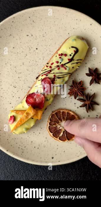 French food, dessert eclair with chocolate filling and covered with ...