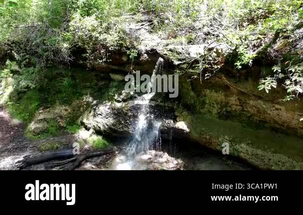 Slow pass over a small waterfall in South Carolina with dappled ...