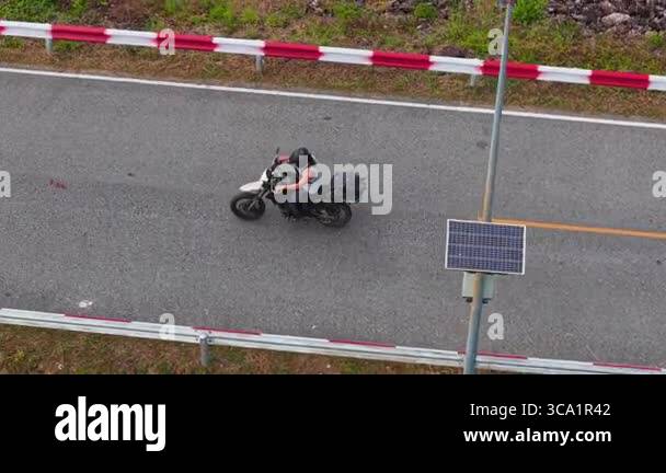 Female motorcyclist enjoying freedom and adventure driving on a ...