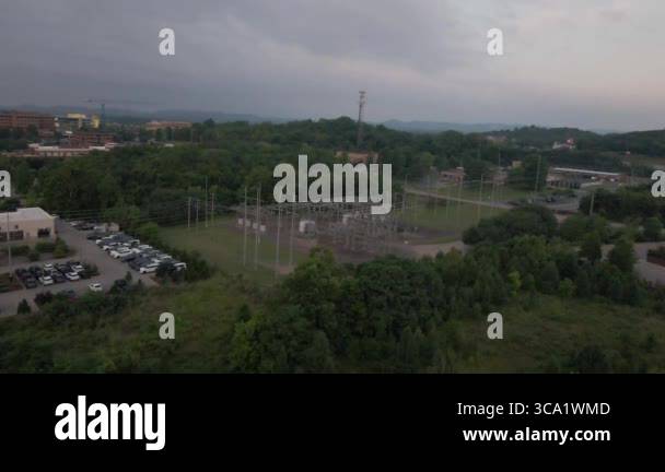 Suburban power substation surrounded by forests and apartment ...