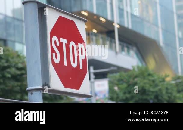 A stop sign stands prominently in an urban area showcasing modern ...