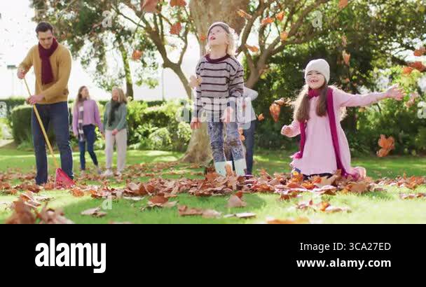 Video of happy caucasian son and daughter throwing autumn leaves while ...