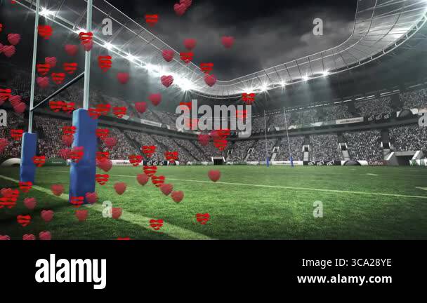 Rugby goal post showing blue padding on turf under floodlights with ...