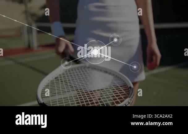 Tennis player balancing tennis ball above racket on green court showing ...