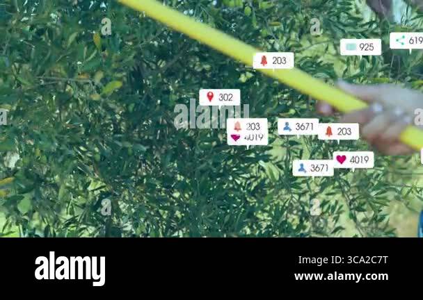 Garden rake cutting through green shrub, displaying floating social ...
