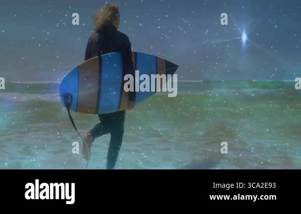 Senior surfer wading in ocean waves, integrating starry sky motion ...