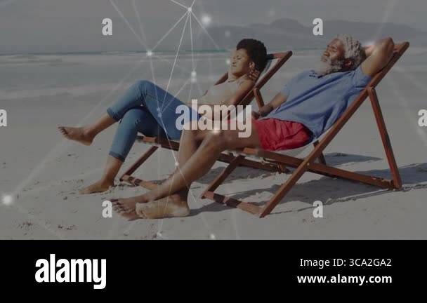 Couple reclining on wooden deck chairs, showing health chart and heart ...