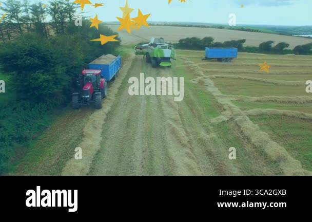 Combine harvester unloading grain into blue trailer at red tractor ...
