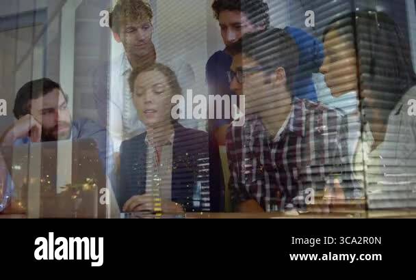 project manager guiding team around laptop in business office, with ...