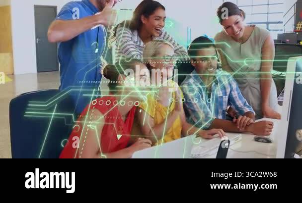 colleagues collaborating around workstation in technology office ...