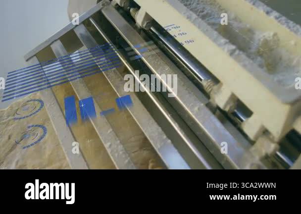 Raw dough sliding on steel slats, showing floating blue charts and ...
