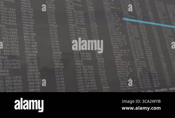 Computer monitor displaying vertical alphanumeric columns with faint ...