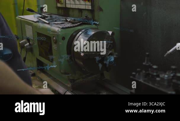 Male technician adjusting lathe controls in workshop, overlaying ...
