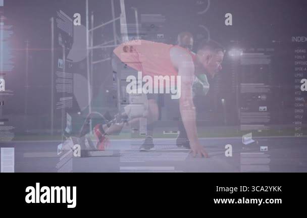 male athlete crouching on blocks at night track, coach observing with ...