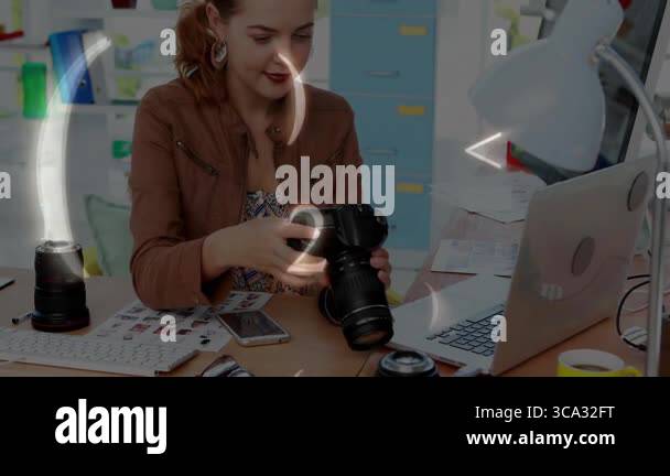 photographer holding smartphone and DSLR reviewing prints in design ...