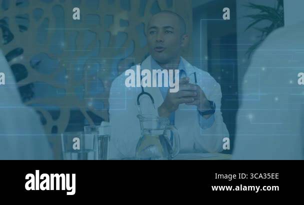 Male doctor gesturing in medical office, displaying digital data ...