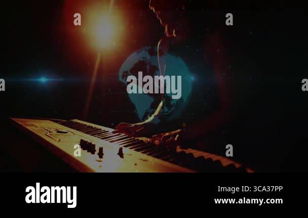 keyboardist performing on dark stage, with holographic globe projecting ...