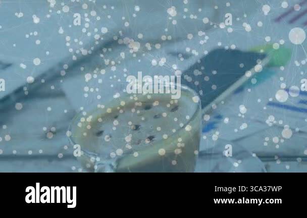 Glass coffee cup floating above wooden desk, showing laptop keyboard ...